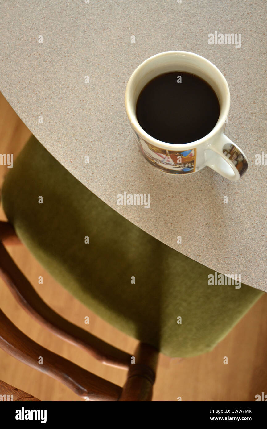 coffee mug on edge of round table, seen from above Stock Photo - Alamy