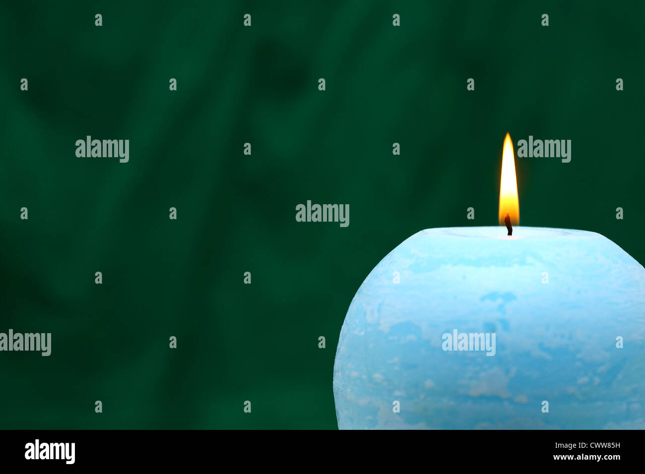 blue candle, green background Stock Photo - Alamy