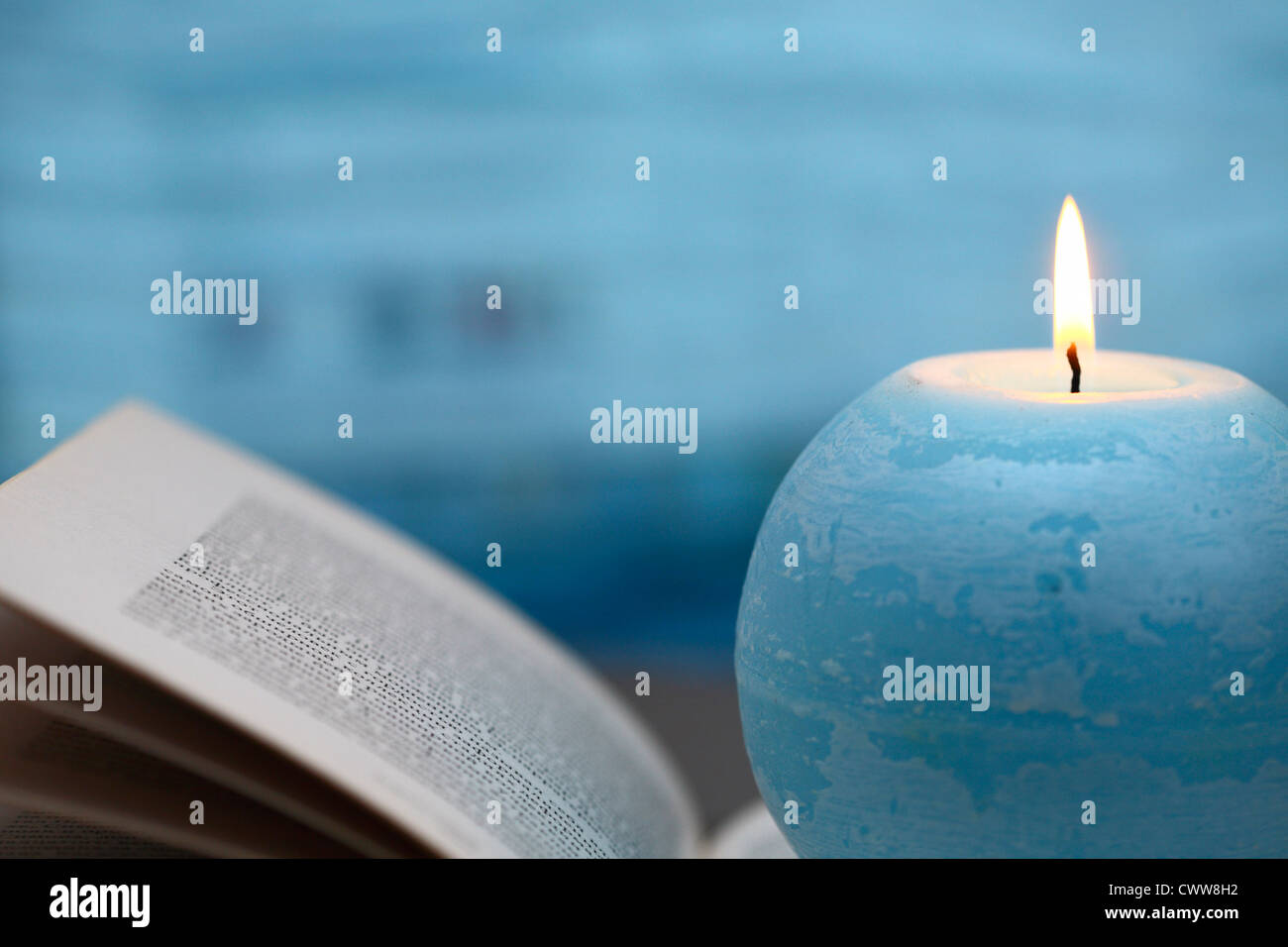 blue candle and book Stock Photo - Alamy