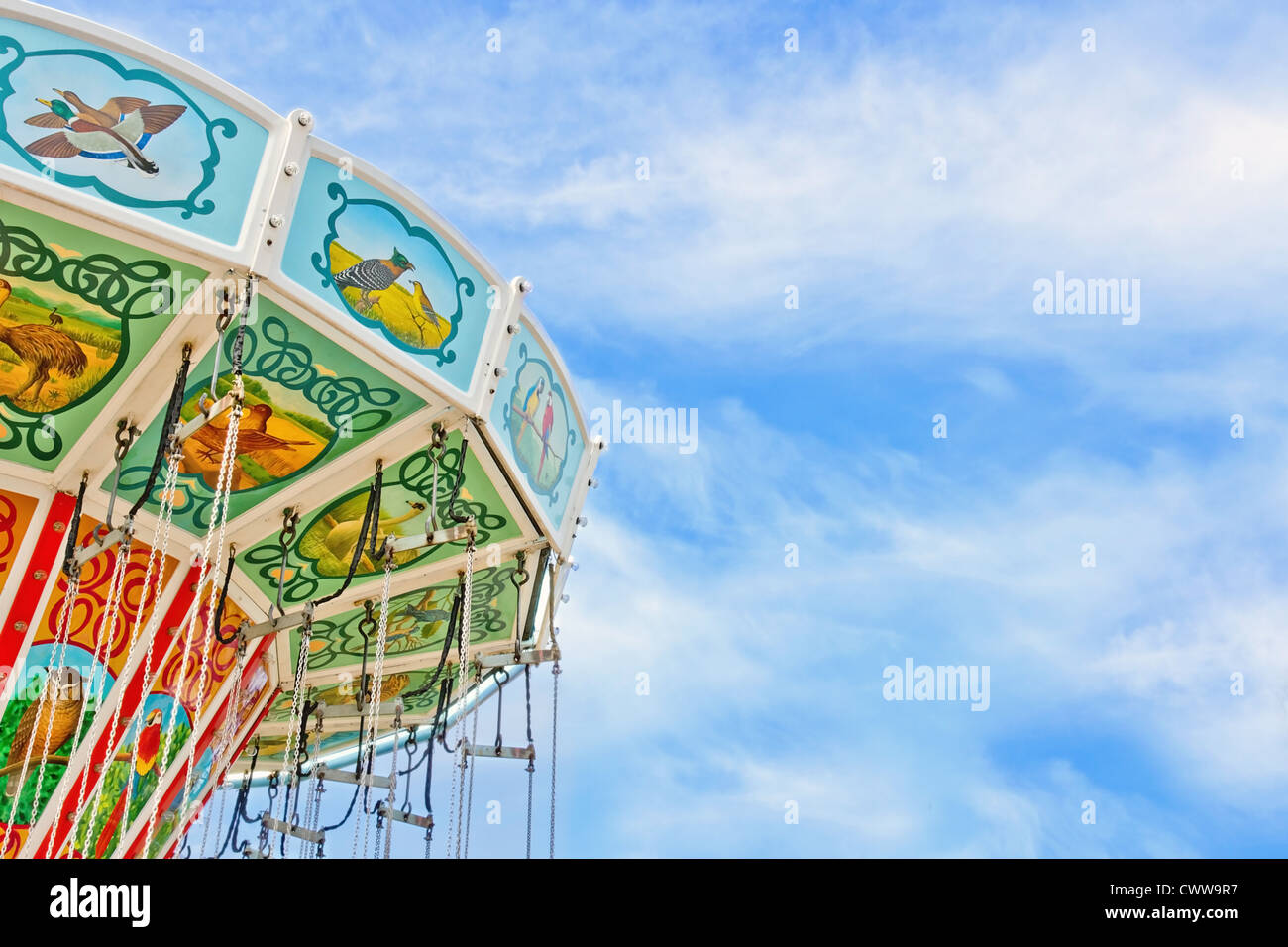 Closeup of a colorful carousel with blue sky background and copy space ...