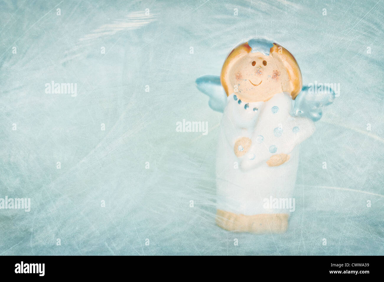 Cute blue colored angel and feathers on textured background Stock Photo ...