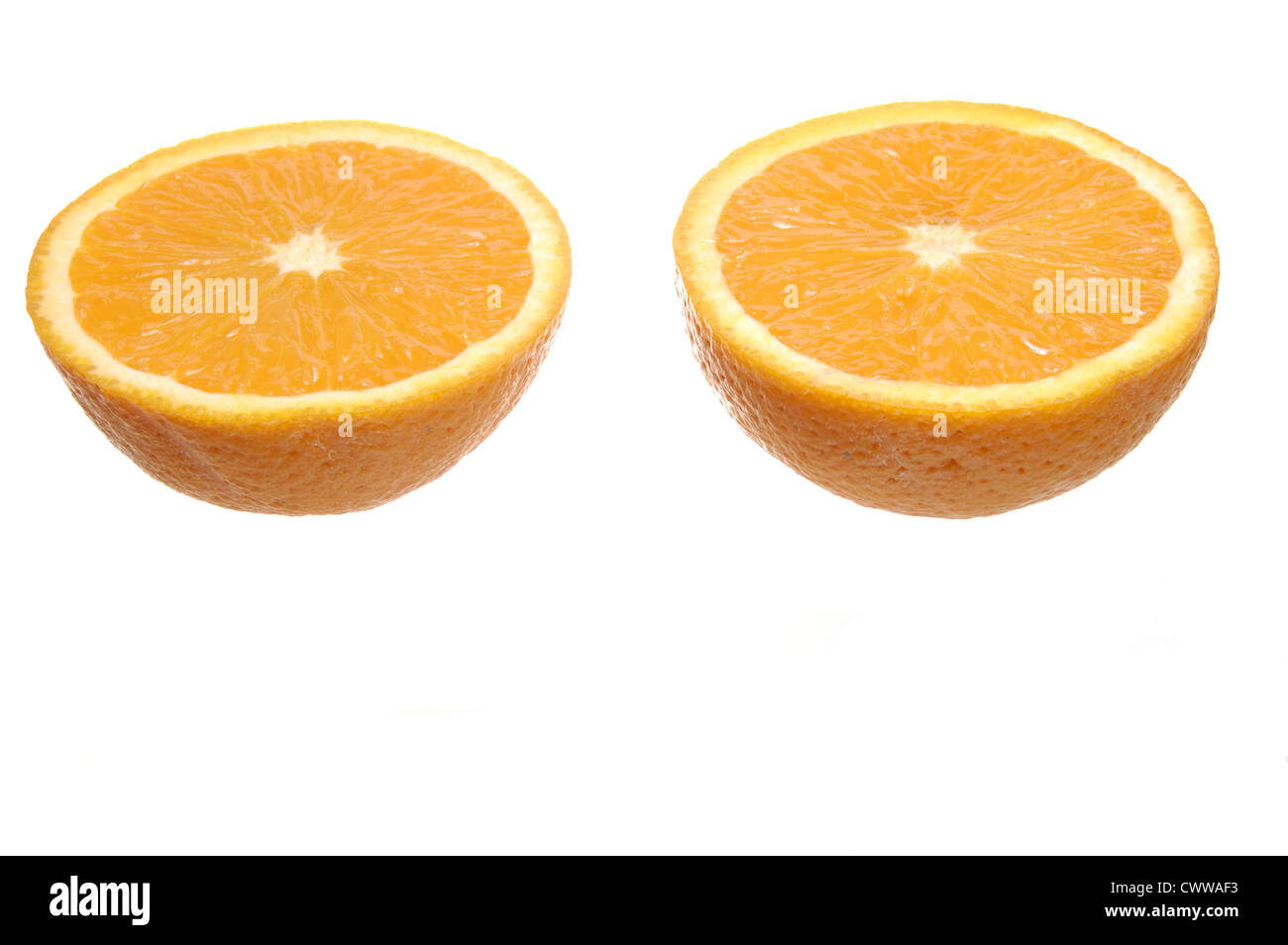 Two orange halves isolated on a white background Stock Photo - Alamy
