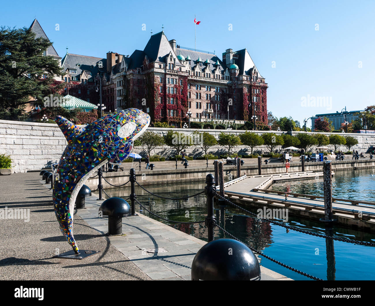 Mosaic sculpture of an orca on the waterfront with Empress Hotel behind ...