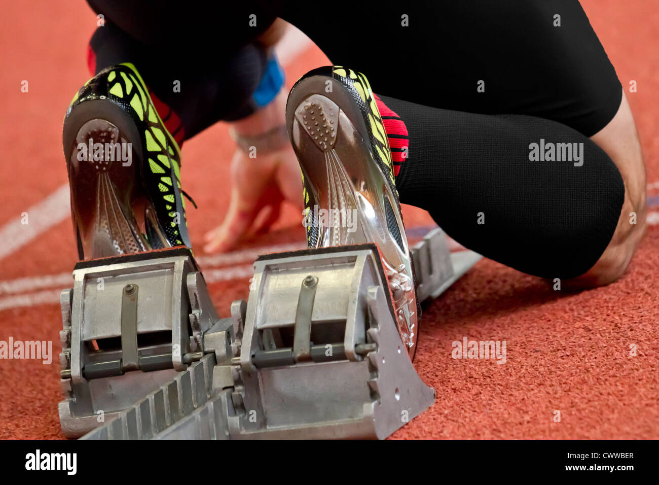 Short distance runner on gravity slope curve is in start position Stock ...