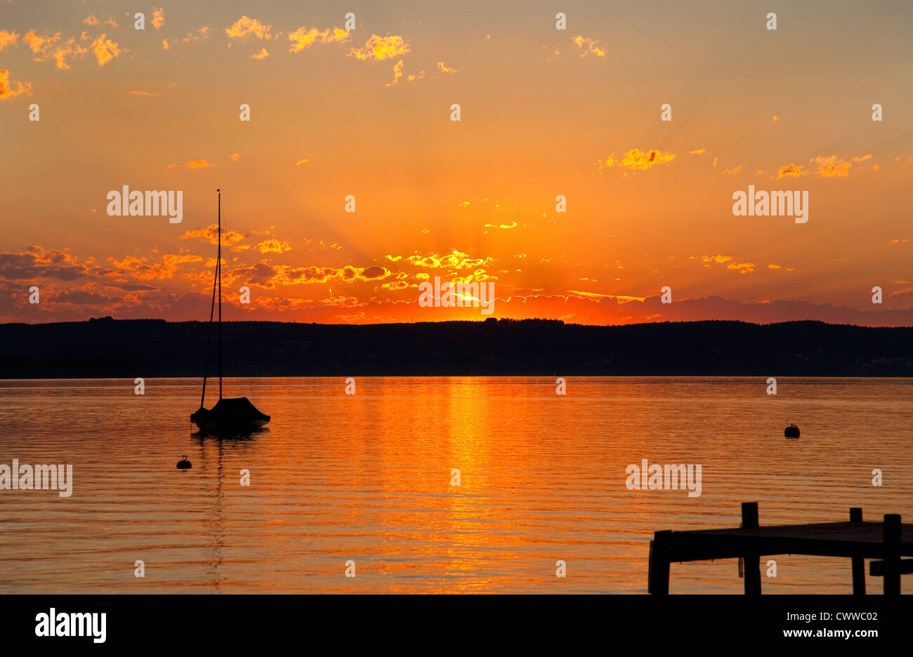 Sun setting over still rural lake Stock Photo - Alamy