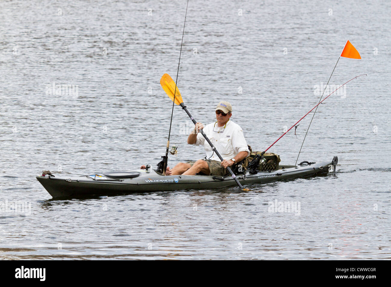 Fisherman paddling kayak on Withlacoochee River near Inverness, Florida ...