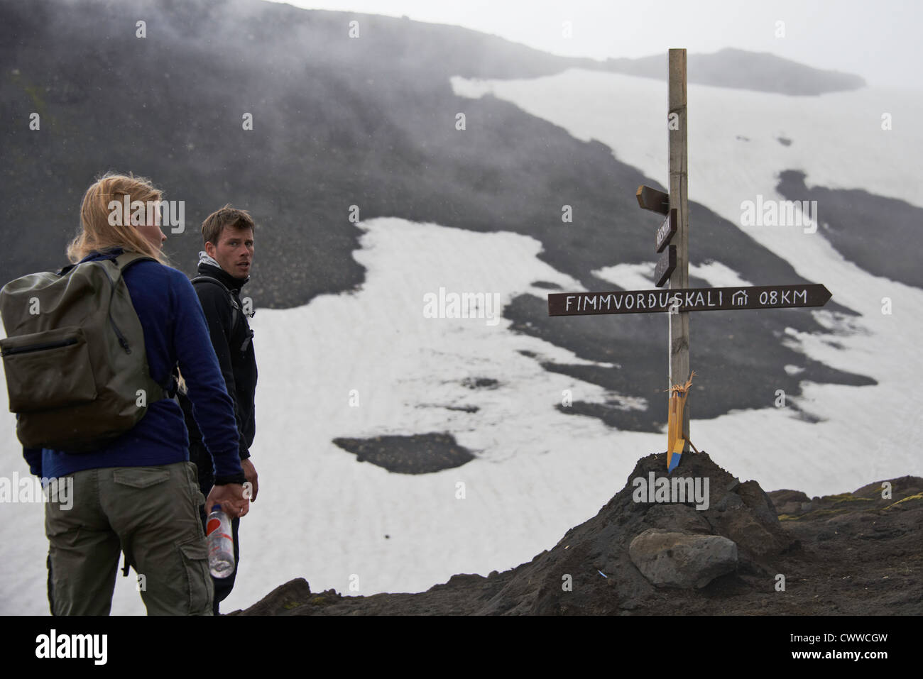 Hikers reading sign on trail Stock Photo - Alamy
