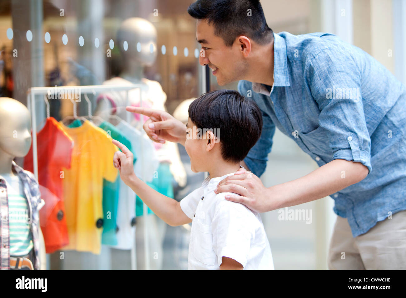 Father and son shopping in department store Stock Photo - Alamy