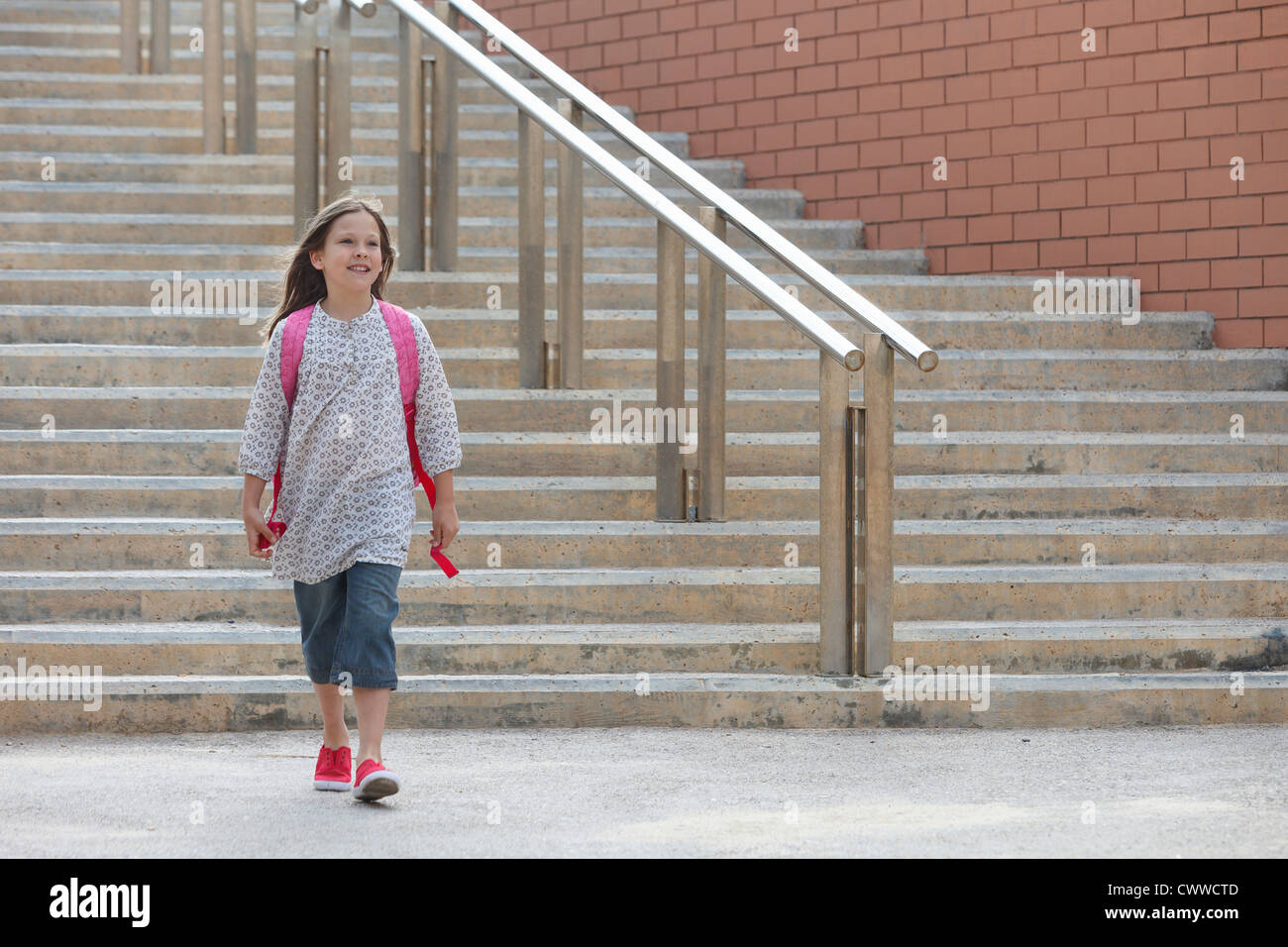 Girl walking by steps outdoors Stock Photo - Alamy