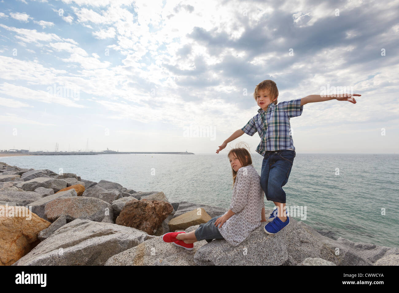 Boy Sitting On Rocks Beach High Resolution Stock Photography and Images ...