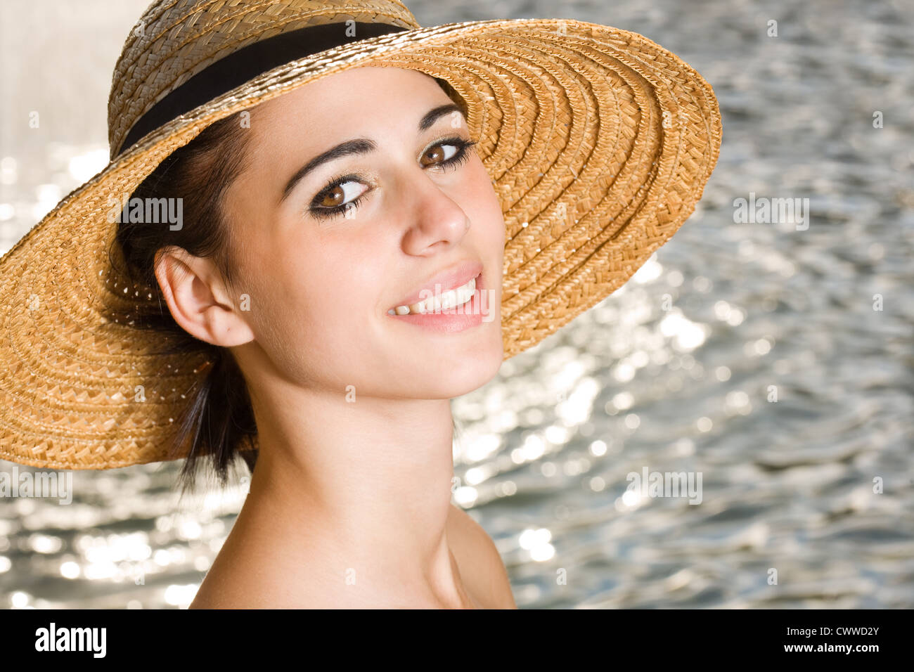 Happy beach brunette portrait, with shiny sunlit sparkling water reflection Stock Photo - Alamy
