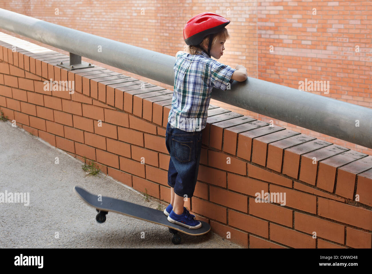 Boy peering over balcony outdoors Stock Photo - Alamy