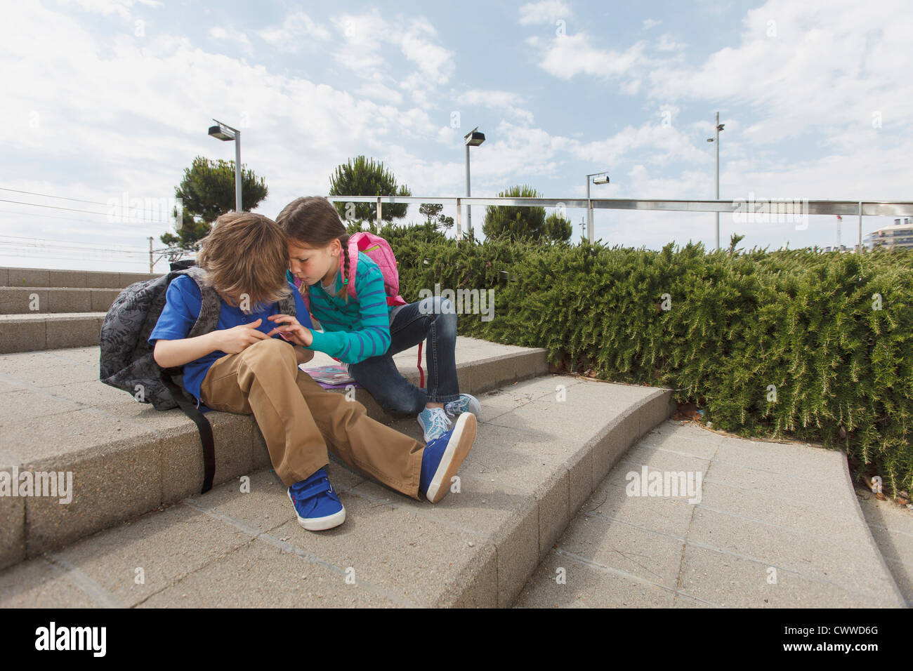 Children talking on steps outdoors Stock Photo - Alamy