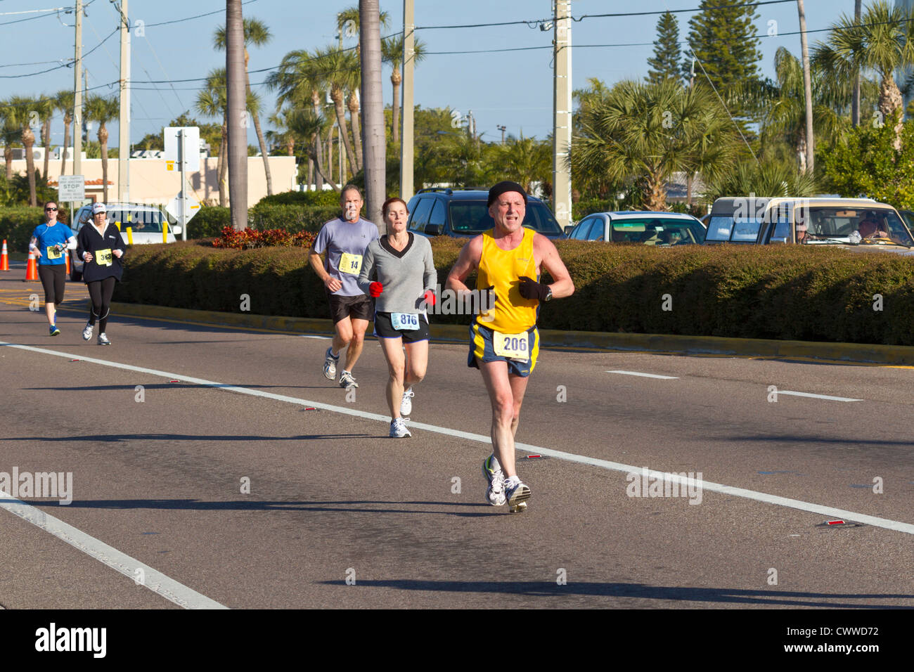 Men and women running in 5k and 10k run on streets of St. Pete Beach ...
