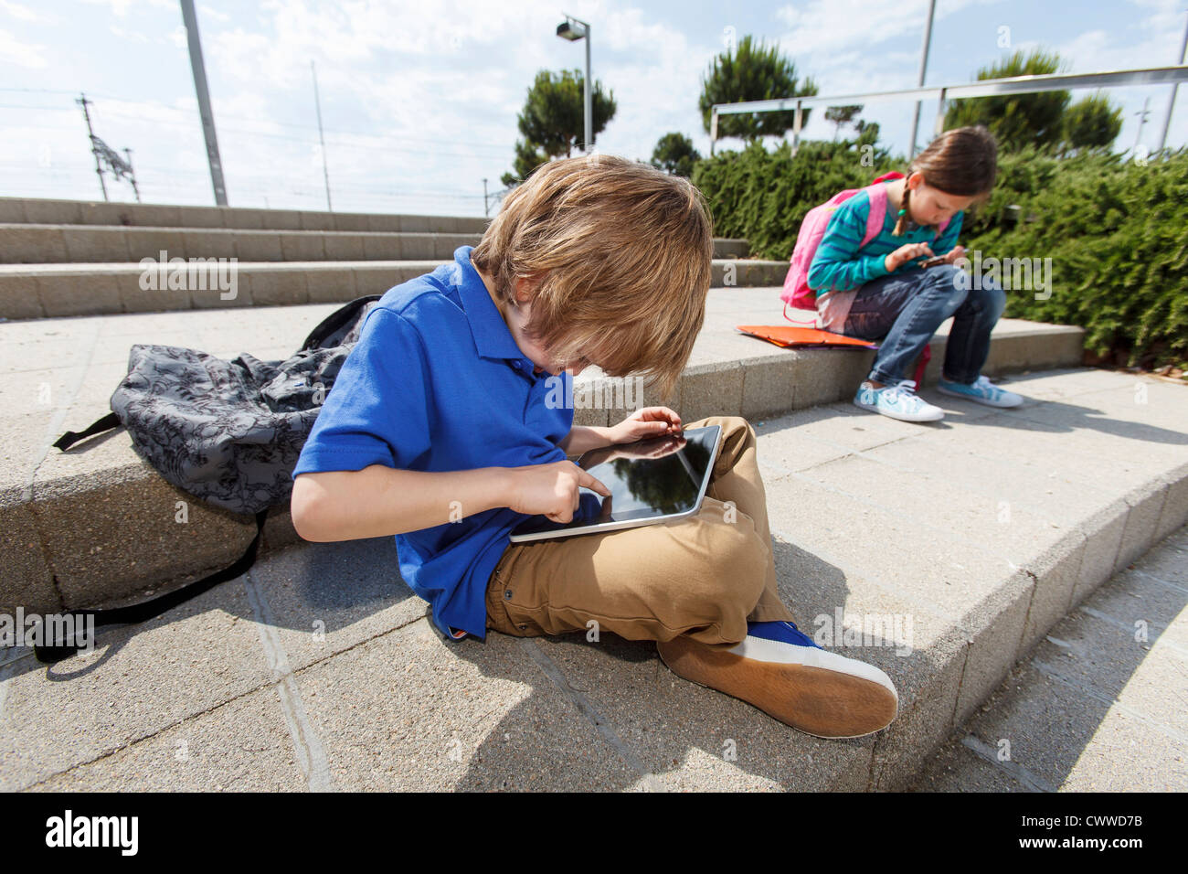 Boy using tablet computer outdoors Stock Photo - Alamy