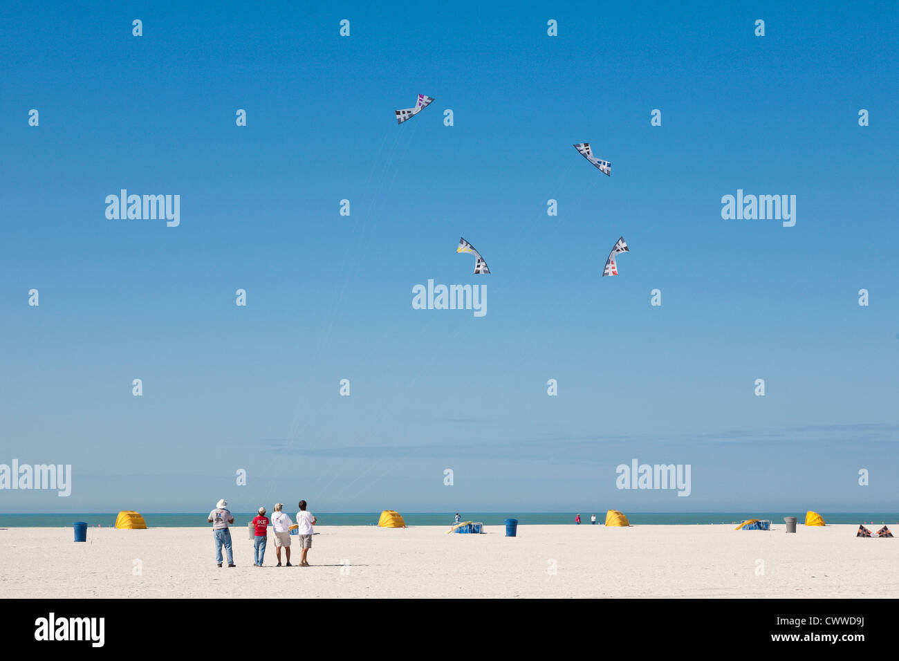 Four men demonstrate synchronized flying on St. Pete Beach at the ...