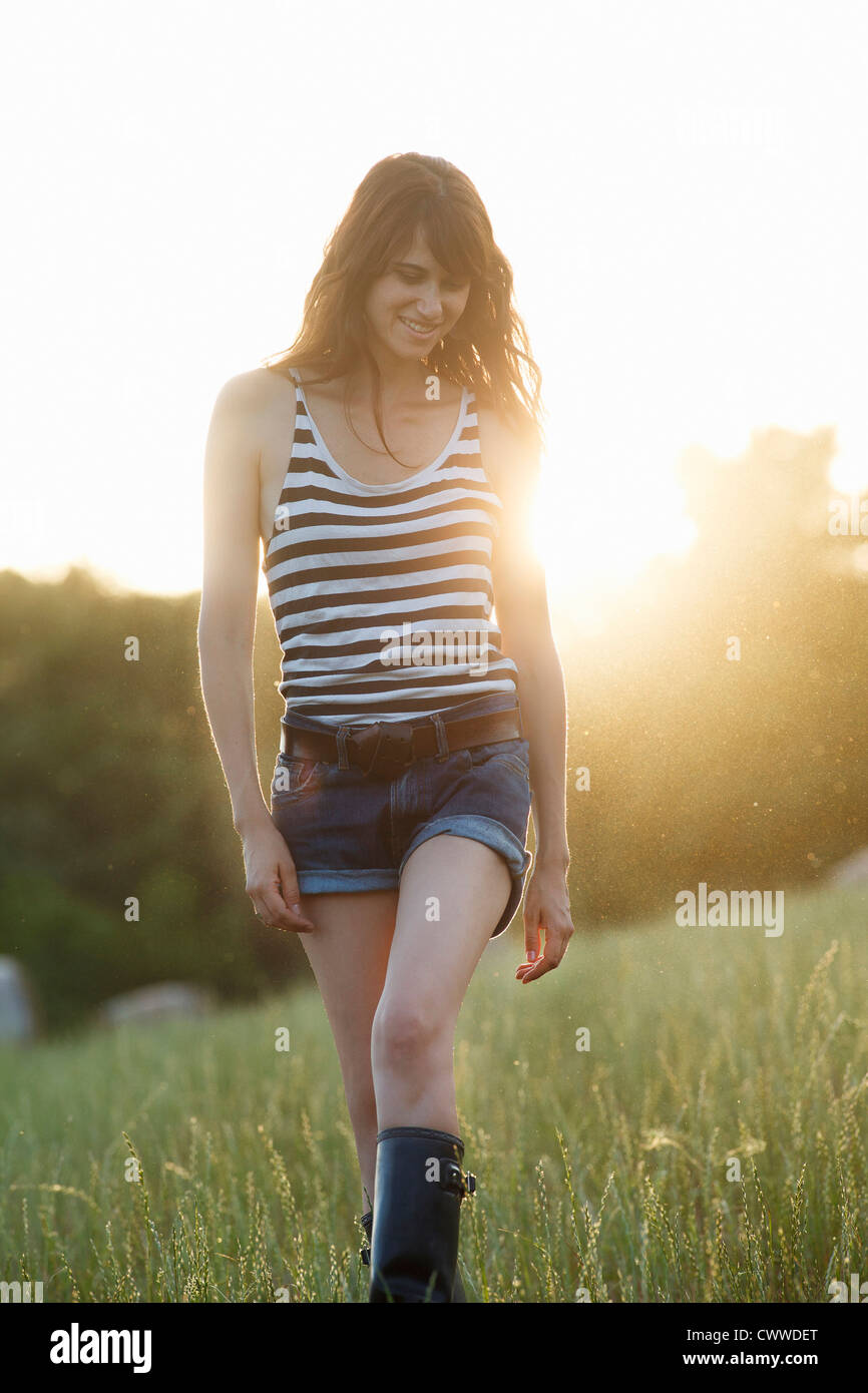 Smiling woman walking outdoors Stock Photo - Alamy