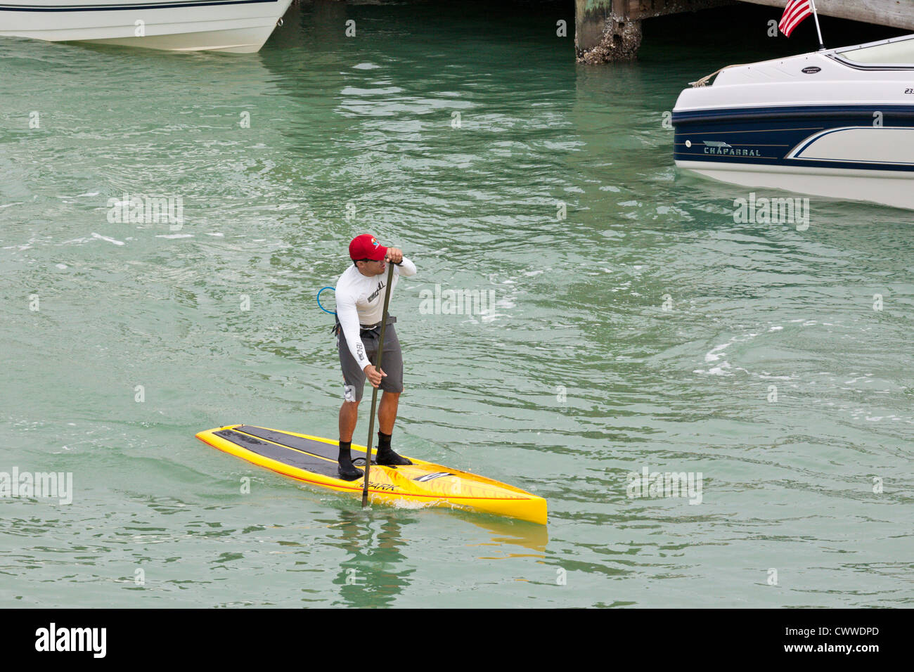 Young man paddle boarding at John's Pass in Treasure Island, Florida ...