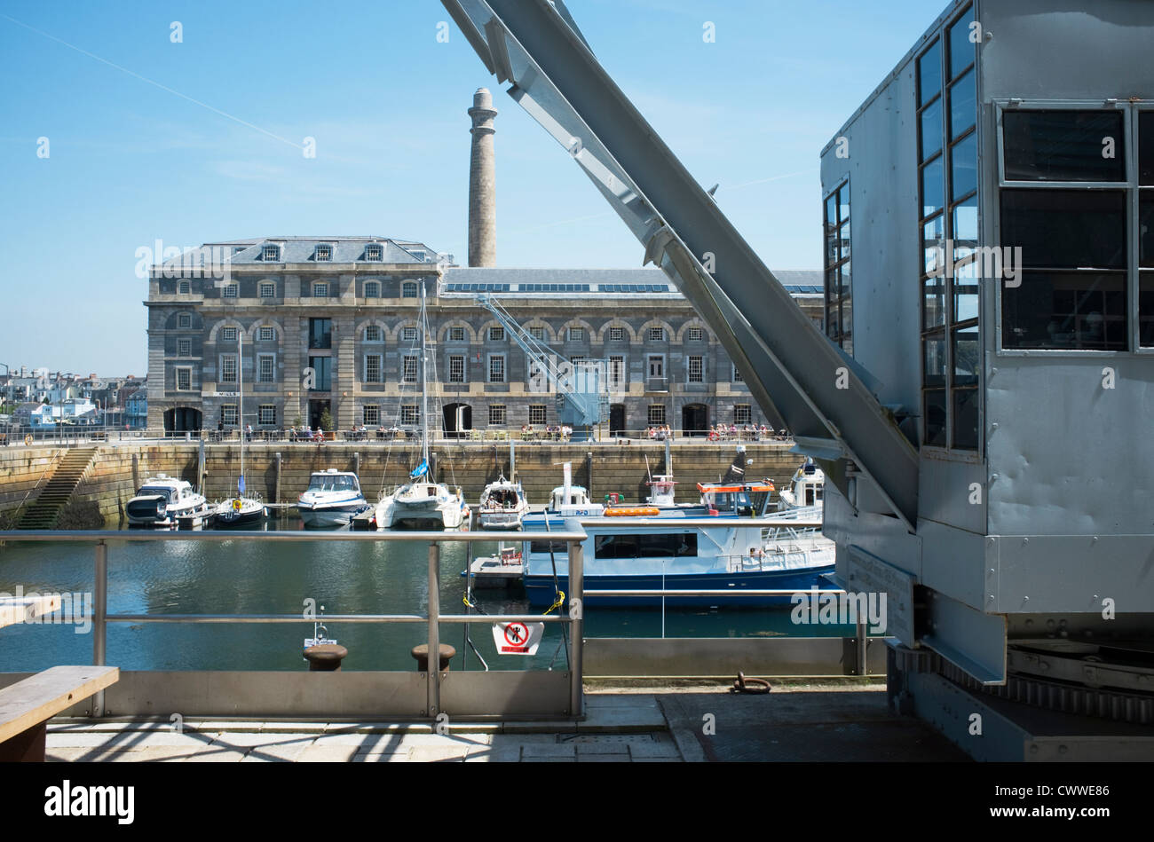 A crane on the quay at renovated Royal William Yard harbour, Plymouth ...