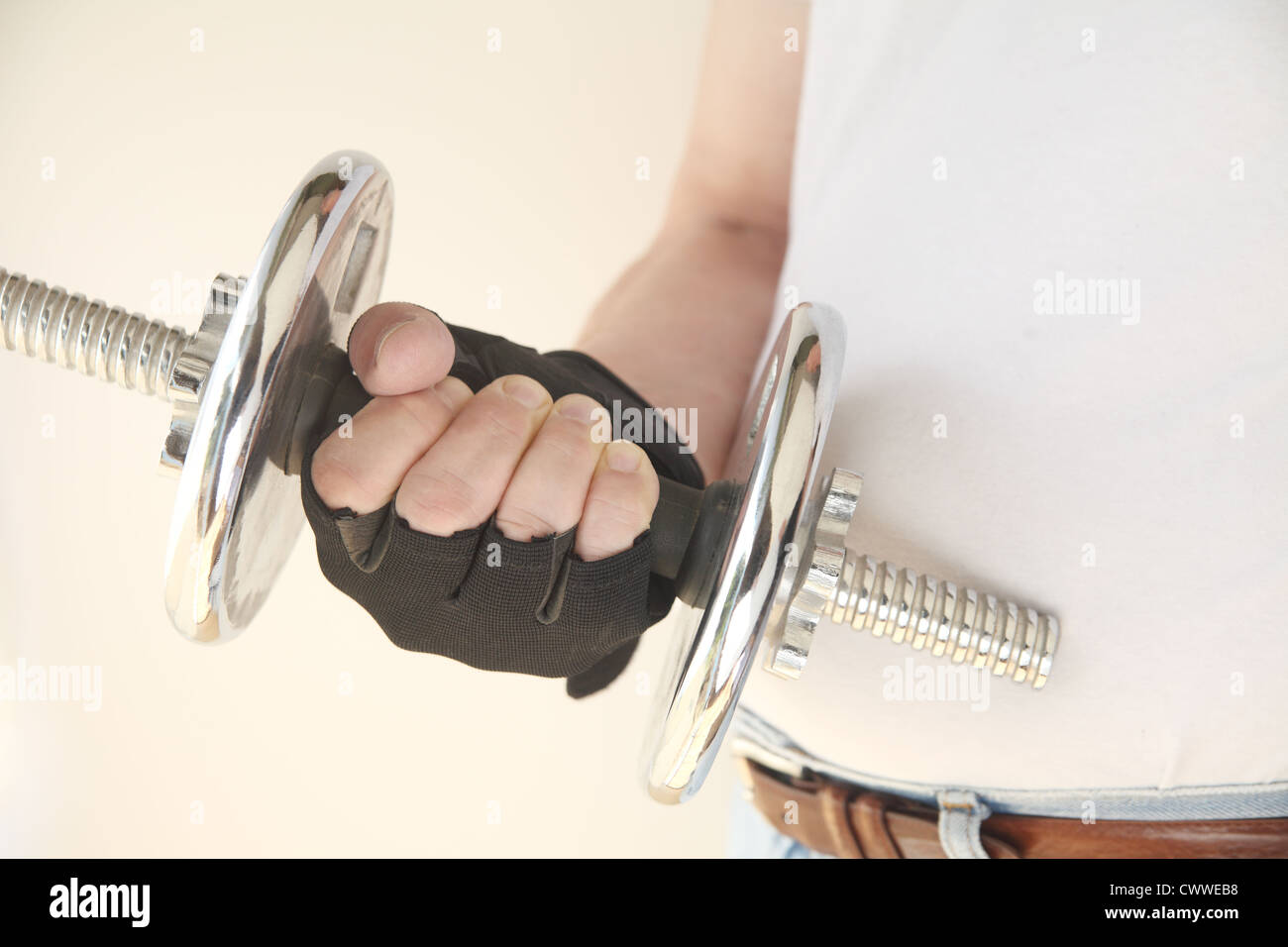 man holds weight in his hand Stock Photo - Alamy