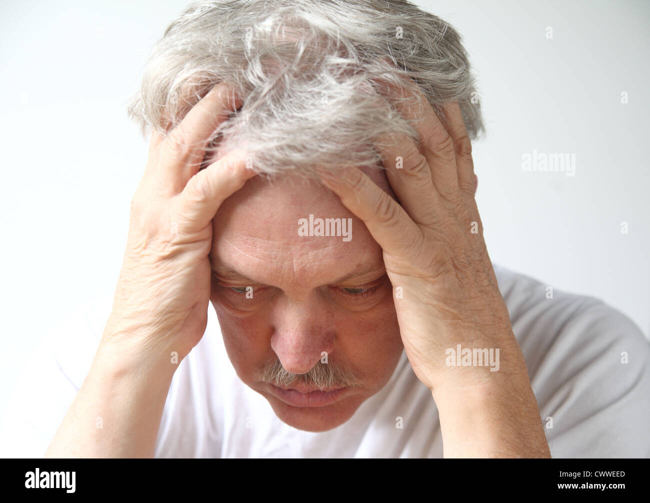 senior man holds his head in despair Stock Photo - Alamy