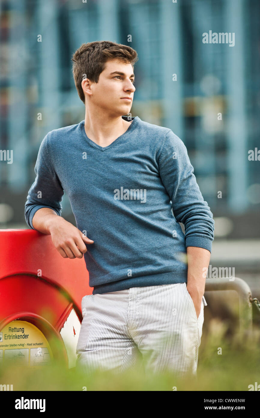 Man standing with hand in pocket Stock Photo - Alamy