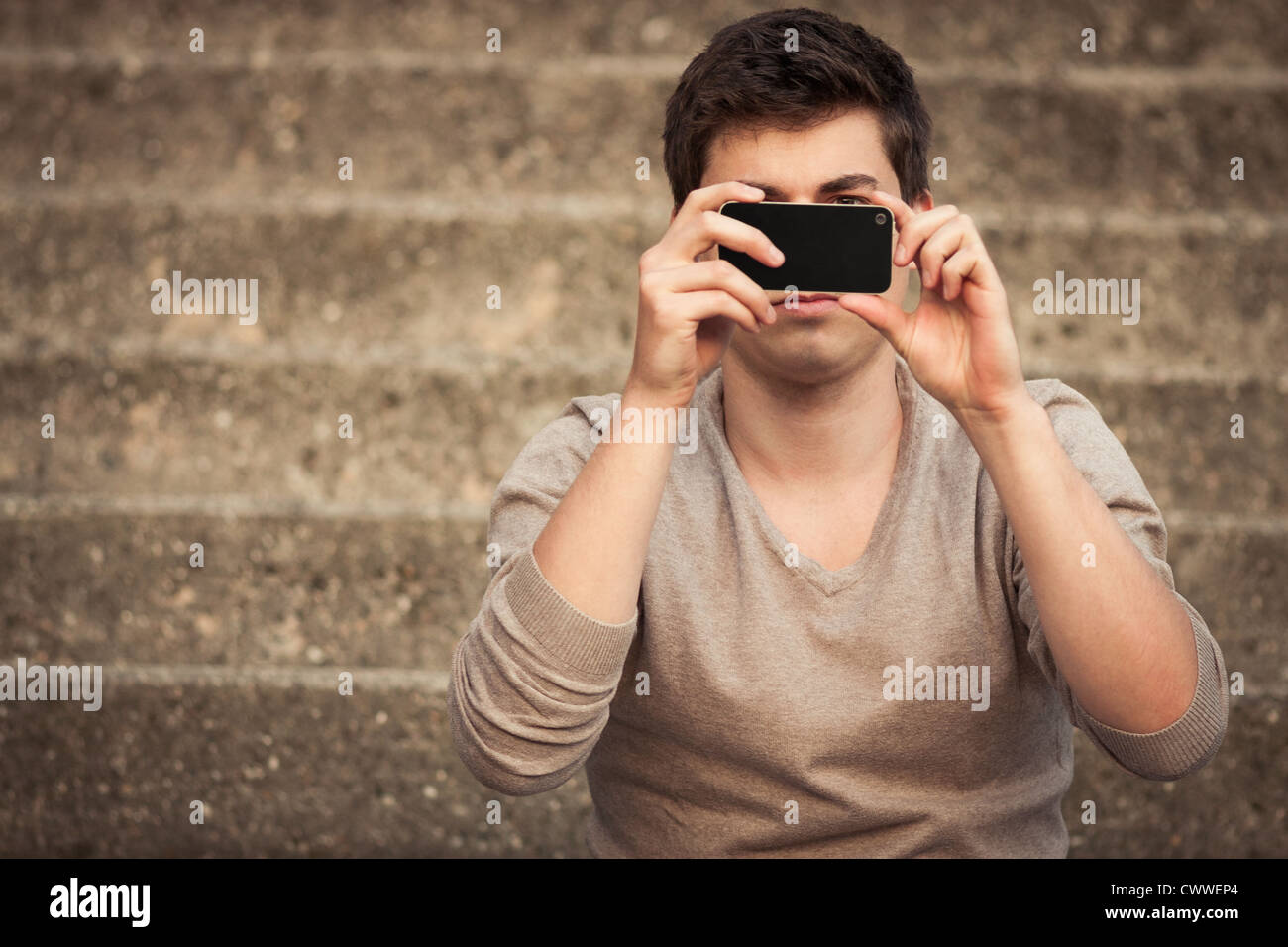Man taking picture with cell phone Stock Photo - Alamy