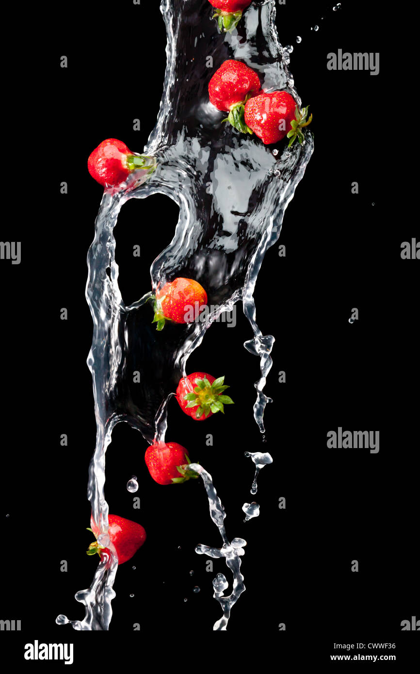 water splash with ripe red strawberry over black background Stock Photo ...