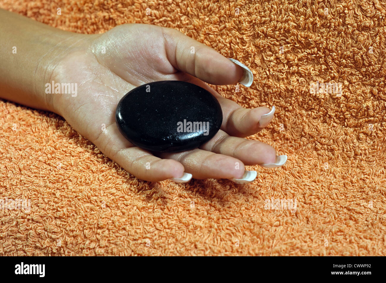 Photo of young woman using stone massage Stock Photo - Alamy