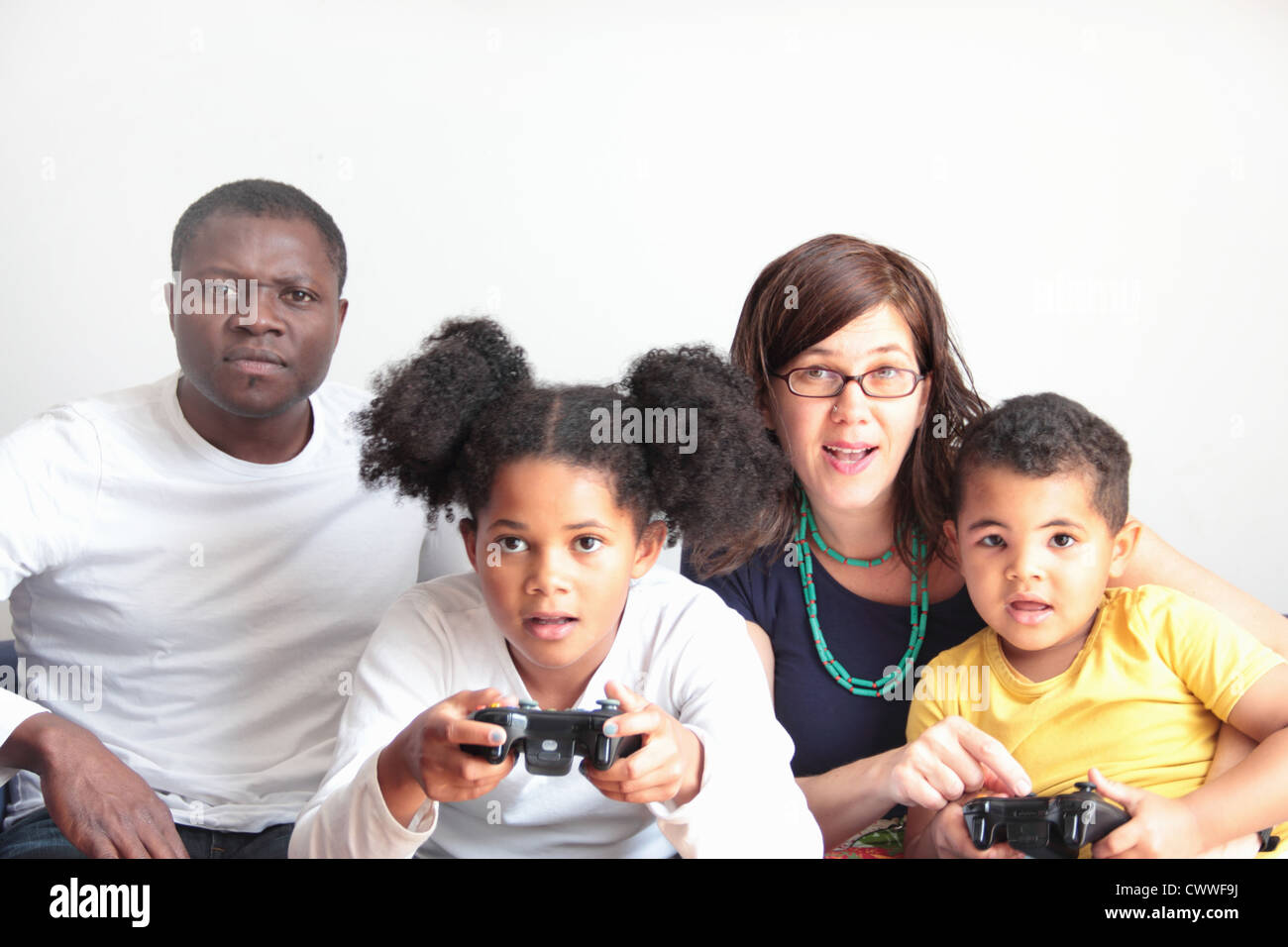 Family playing video games together Stock Photo - Alamy
