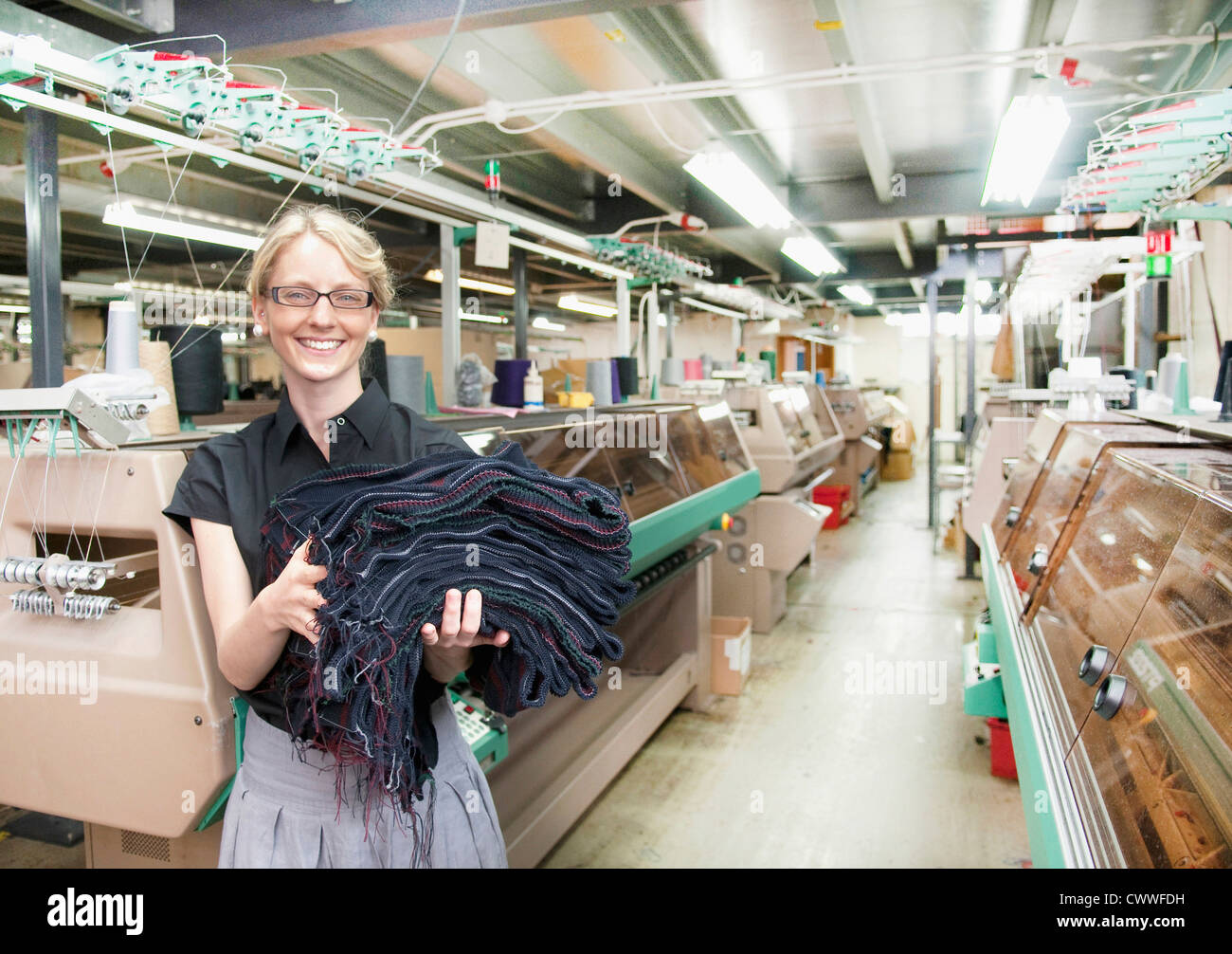 Worker with fabric in garment factory Stock Photo - Alamy
