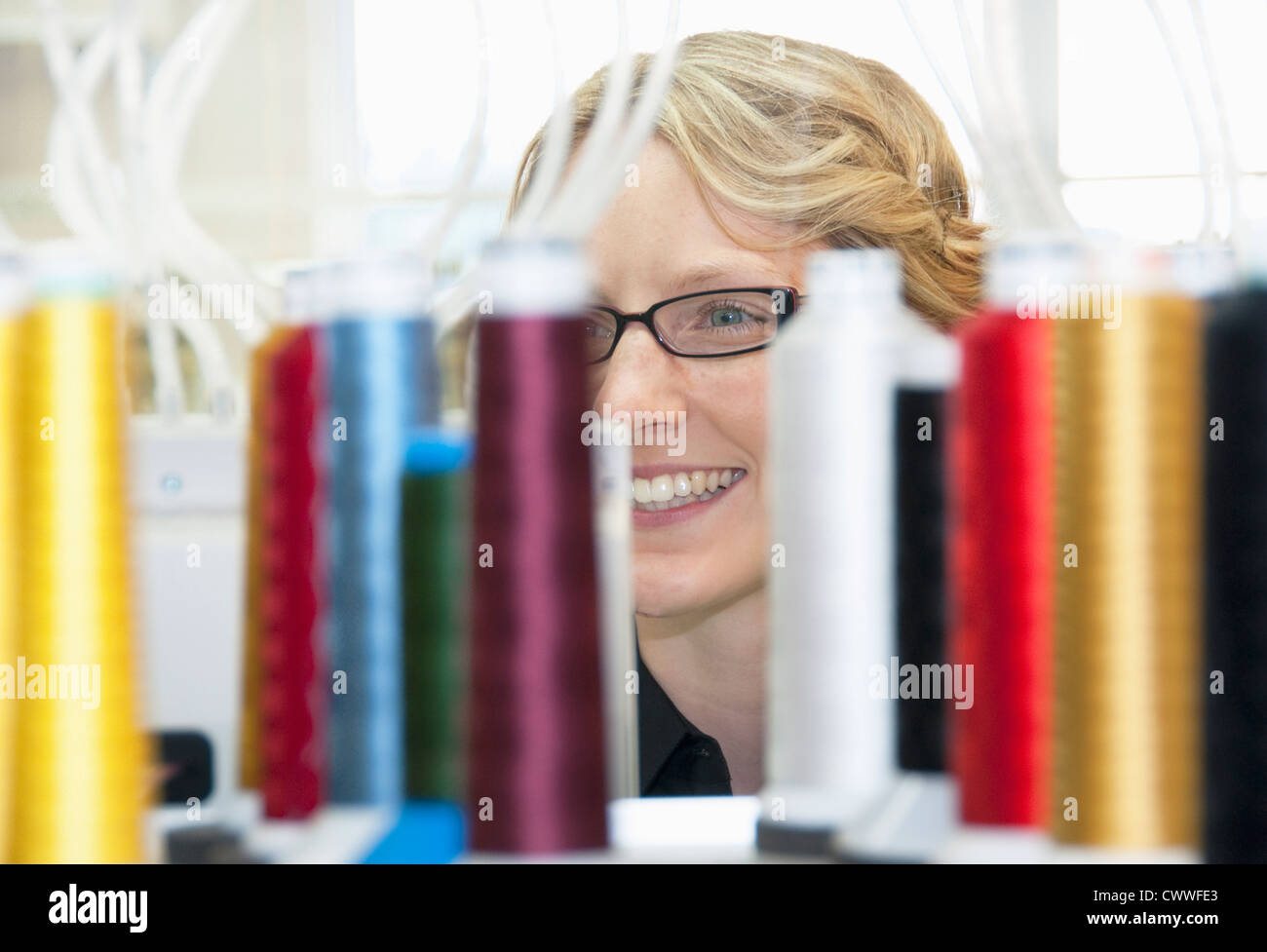 Woman working cloth spools hi-res stock photography and images - Alamy
