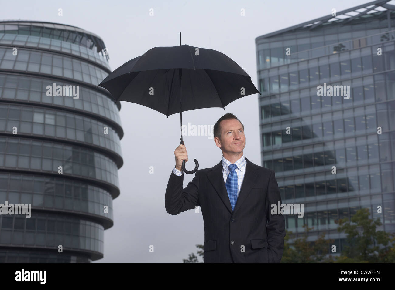Businessman standing under umbrella Stock Photo - Alamy Businessman standing under umbrella Stock Photo - Alamy