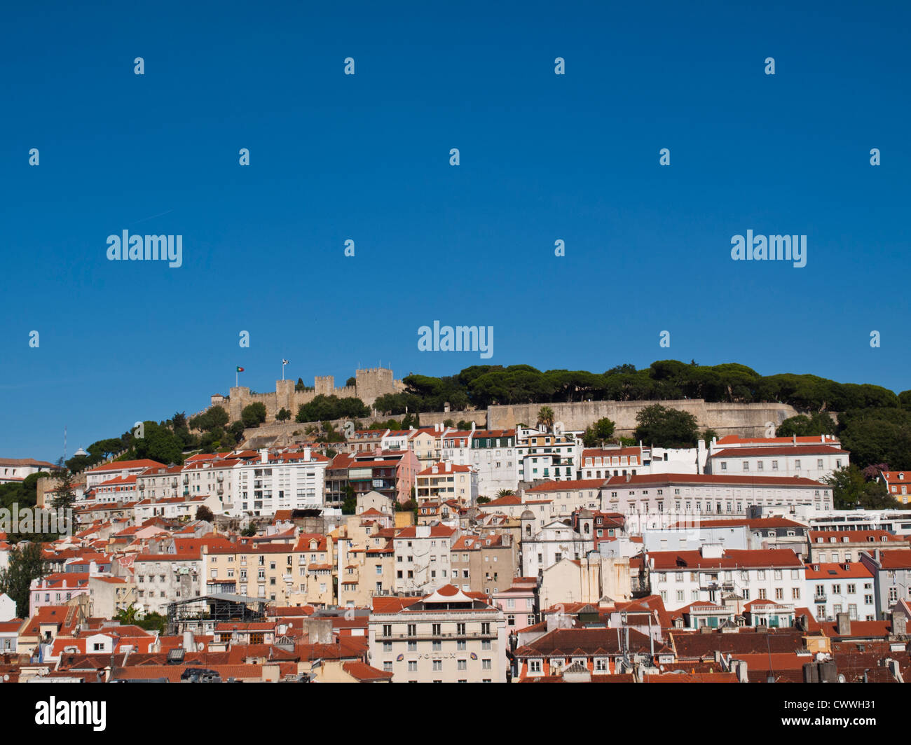 Lisbon St George Castle on top of the hill with houses below and blue ...