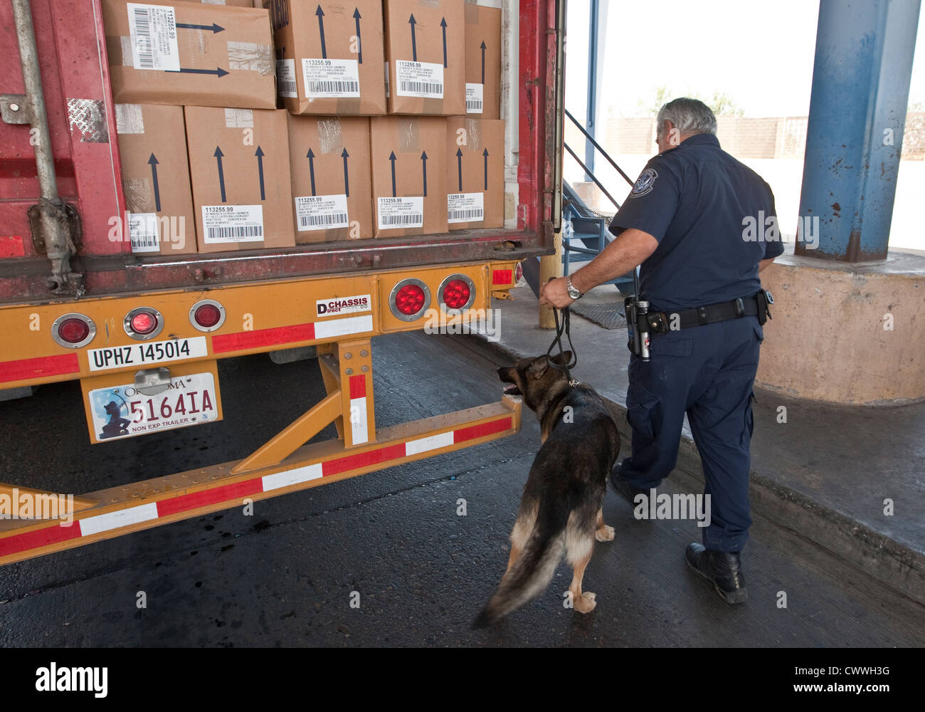 Customs and Border Protection officers check trucks for possible drugs ...