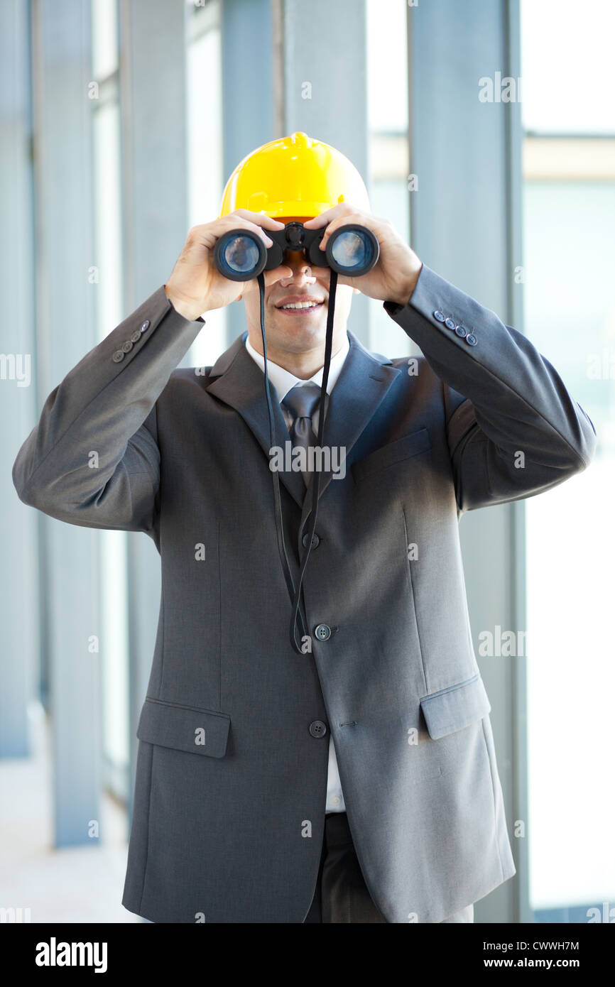 Smiling businessman using binoculars hi-res stock photography and ...