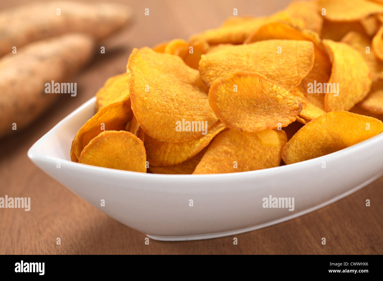 Crispy Peruvian sweet potato chips in white ceramic bowl with sweet ...