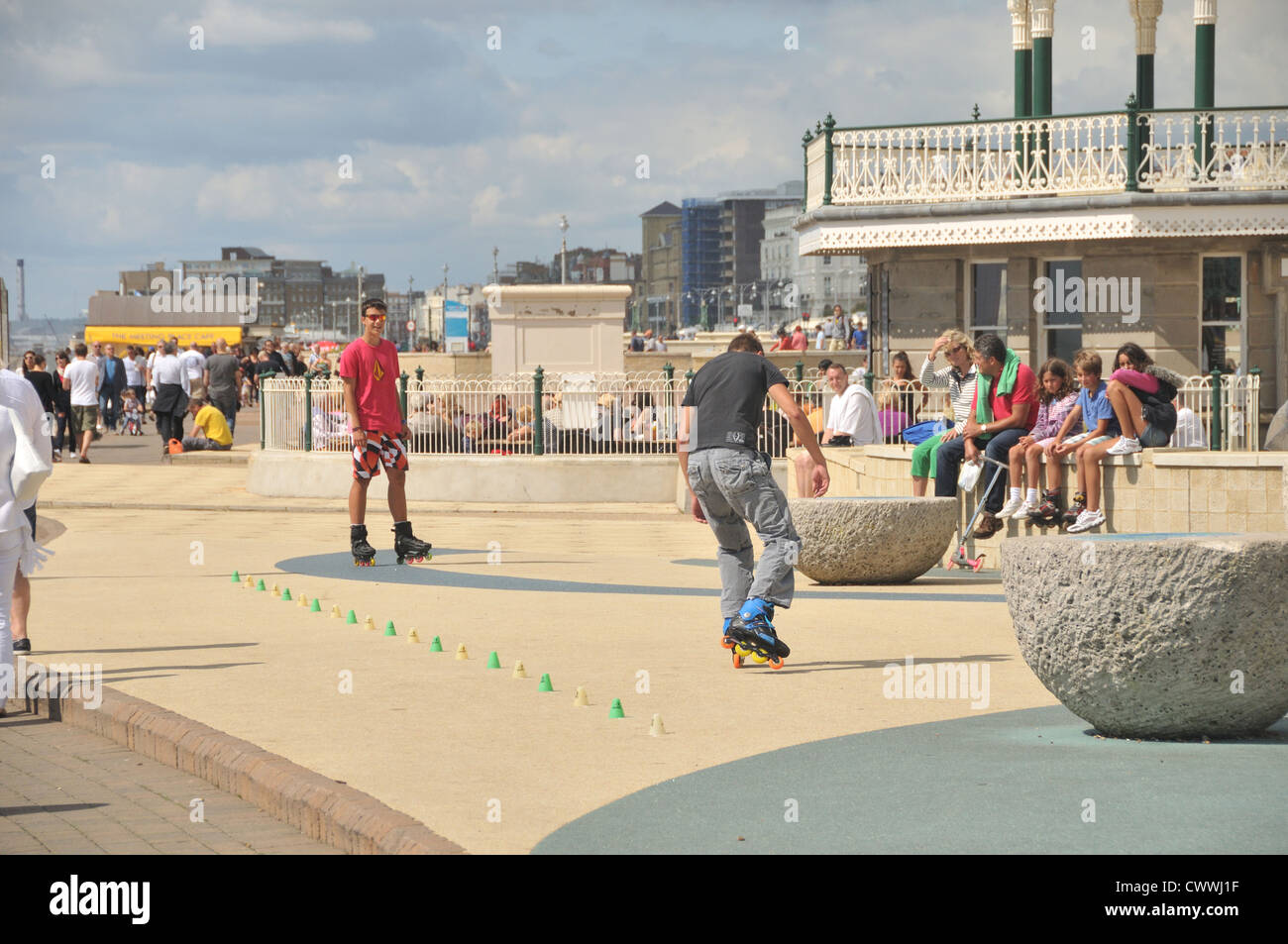 Busy Brighton and Hove seafront in summer (with the Brighton Bandstand ...