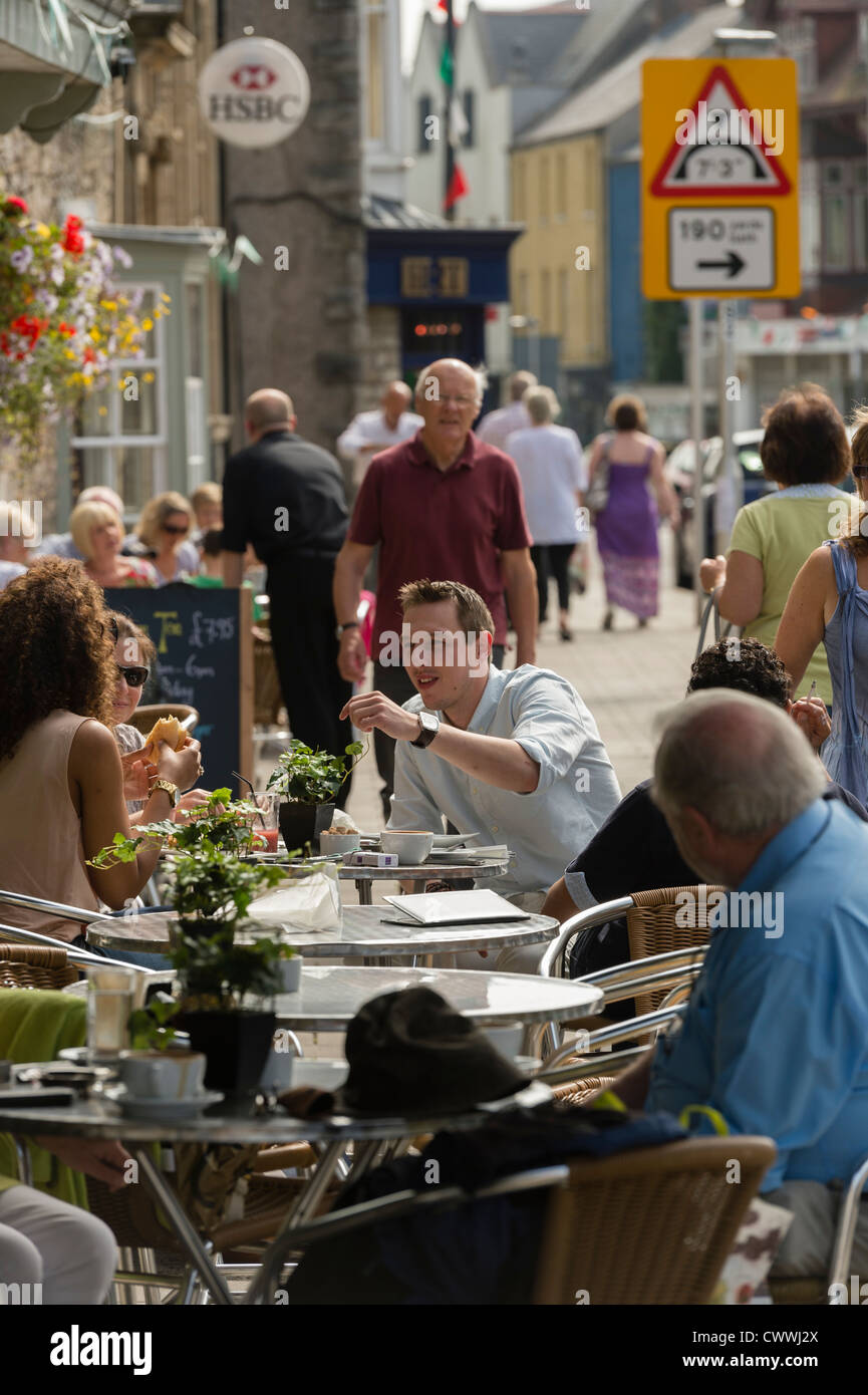 People sitting in the sunshine at outdoor tables of Oscar's cafe bar in ...