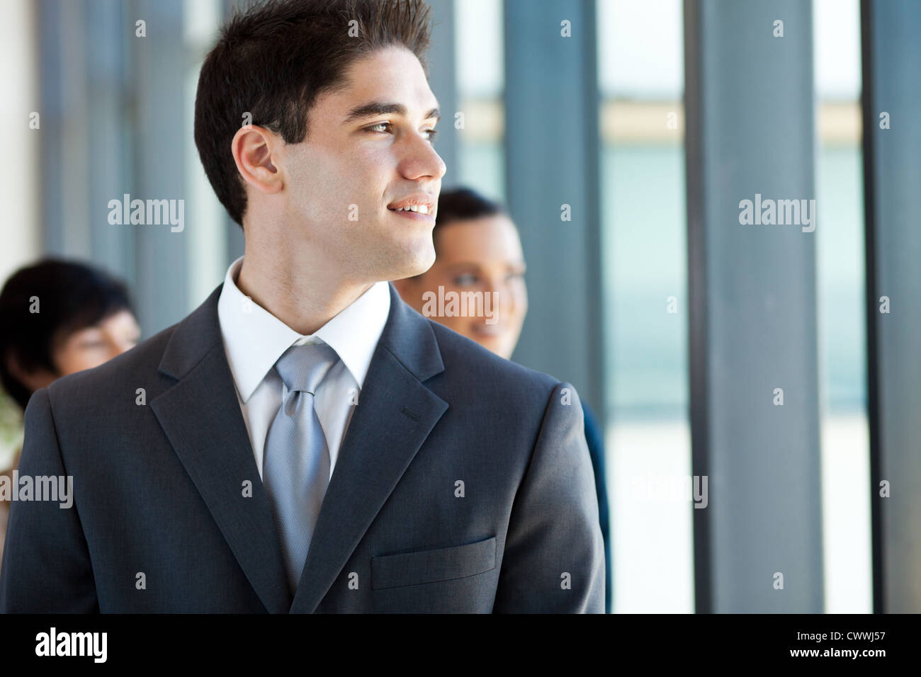 young businessman looking outside office window Stock Photo - Alamy