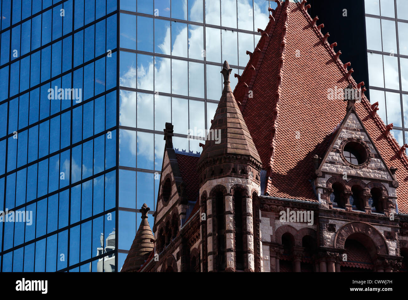 Trinity Church and reflective glass of the Hancock Tower in Boston ...
