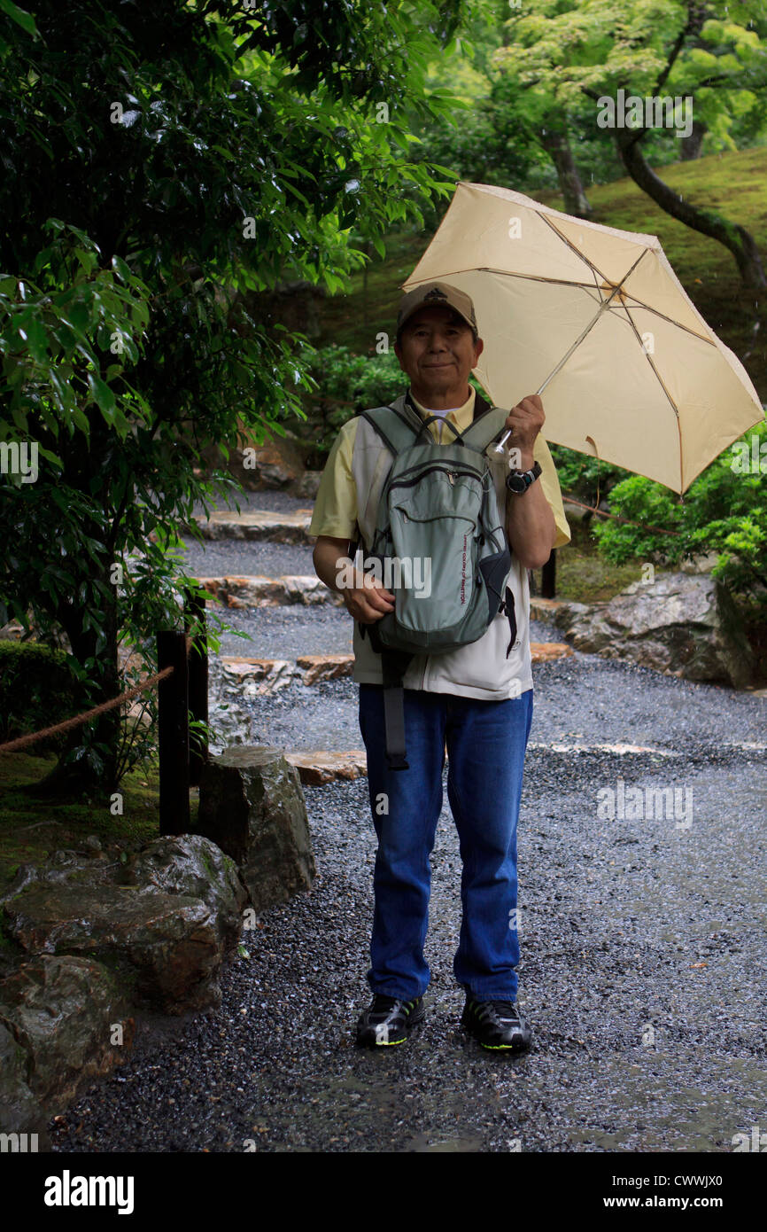 A Japanese man poses for the camera with his umbrella at the Golden ...