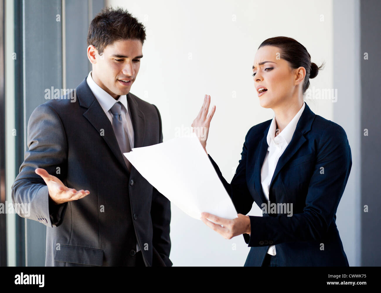 two young colleagues arguing over paperwork in office Stock Photo - Alamy