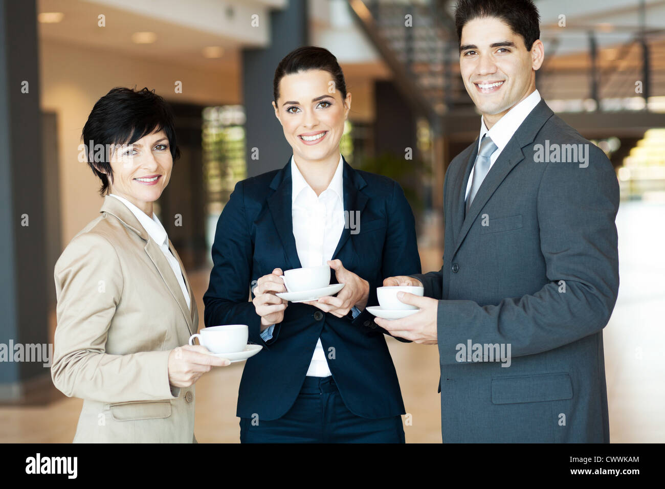 group of colleagues having coffee break at work Stock Photo - Alamy