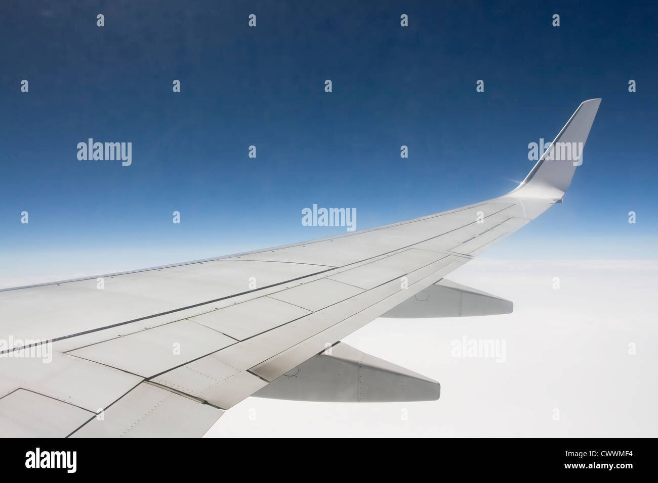 View of jet plane wing with cloud patterns Stock Photo - Alamy