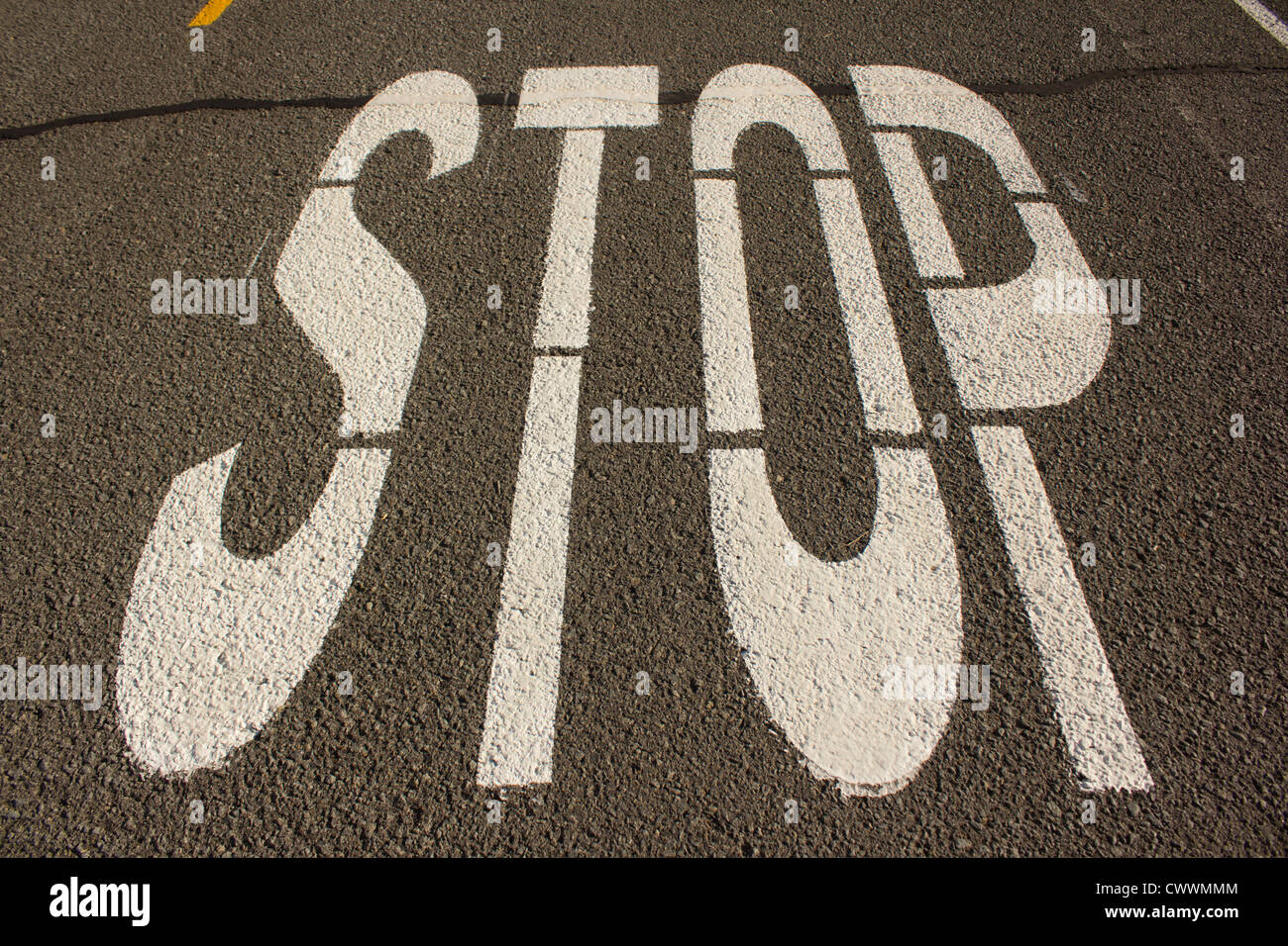 Stop letters in white paint on a road Stock Photo - Alamy