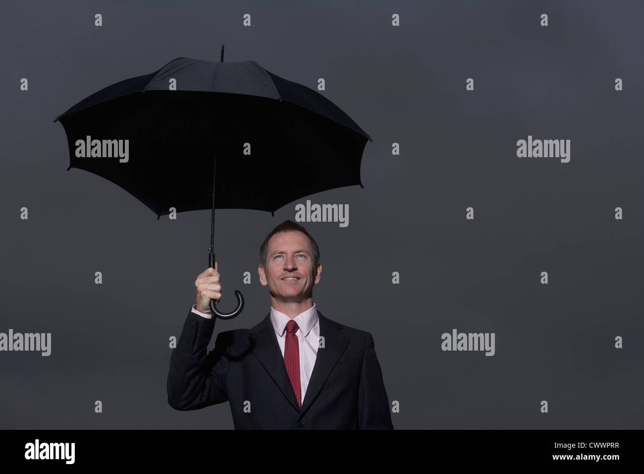 Businessman standing under umbrella Stock Photo - Alamy Businessman standing under umbrella Stock Photo - Alamy