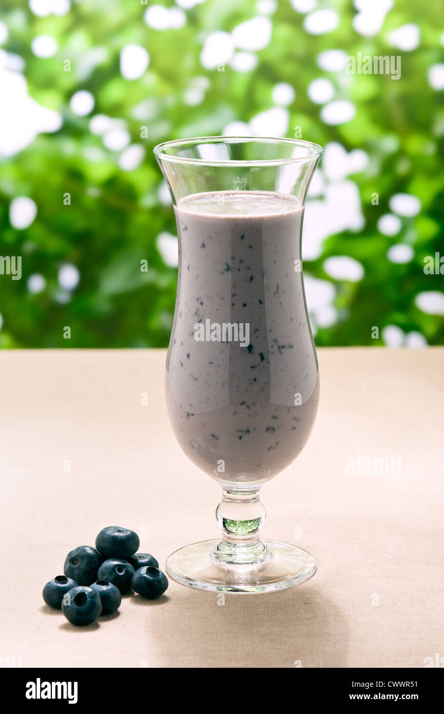 Blueberry milk shake with real fruit and a green background Stock Photo ...