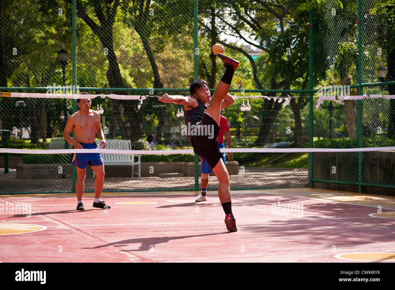 Asian men playing takraw in the park Stock Photo - Alamy
