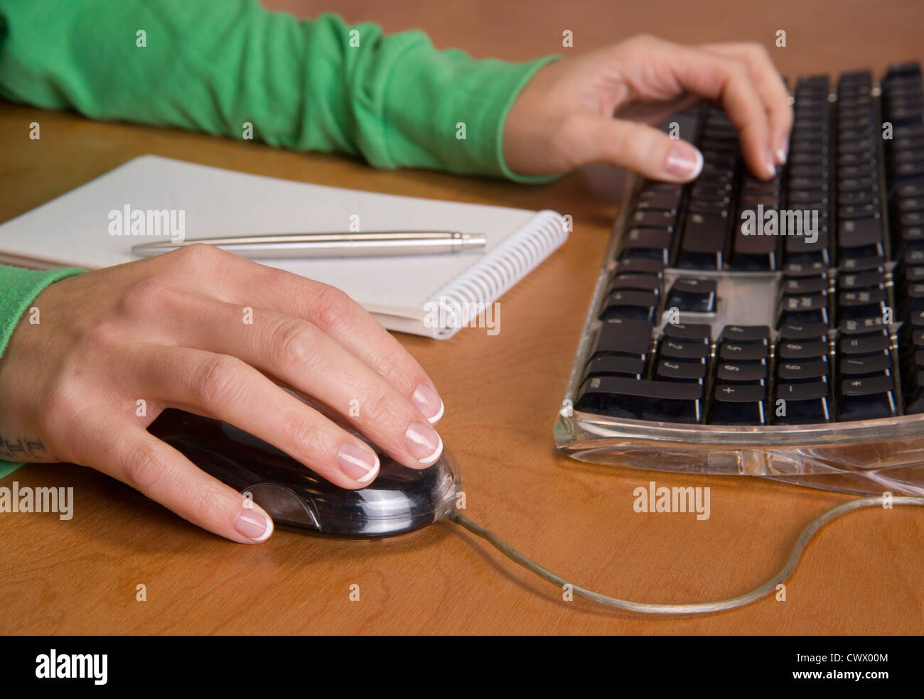 A beautiful set of hands work on the mouse and keyboard Stock Photo - Alamy